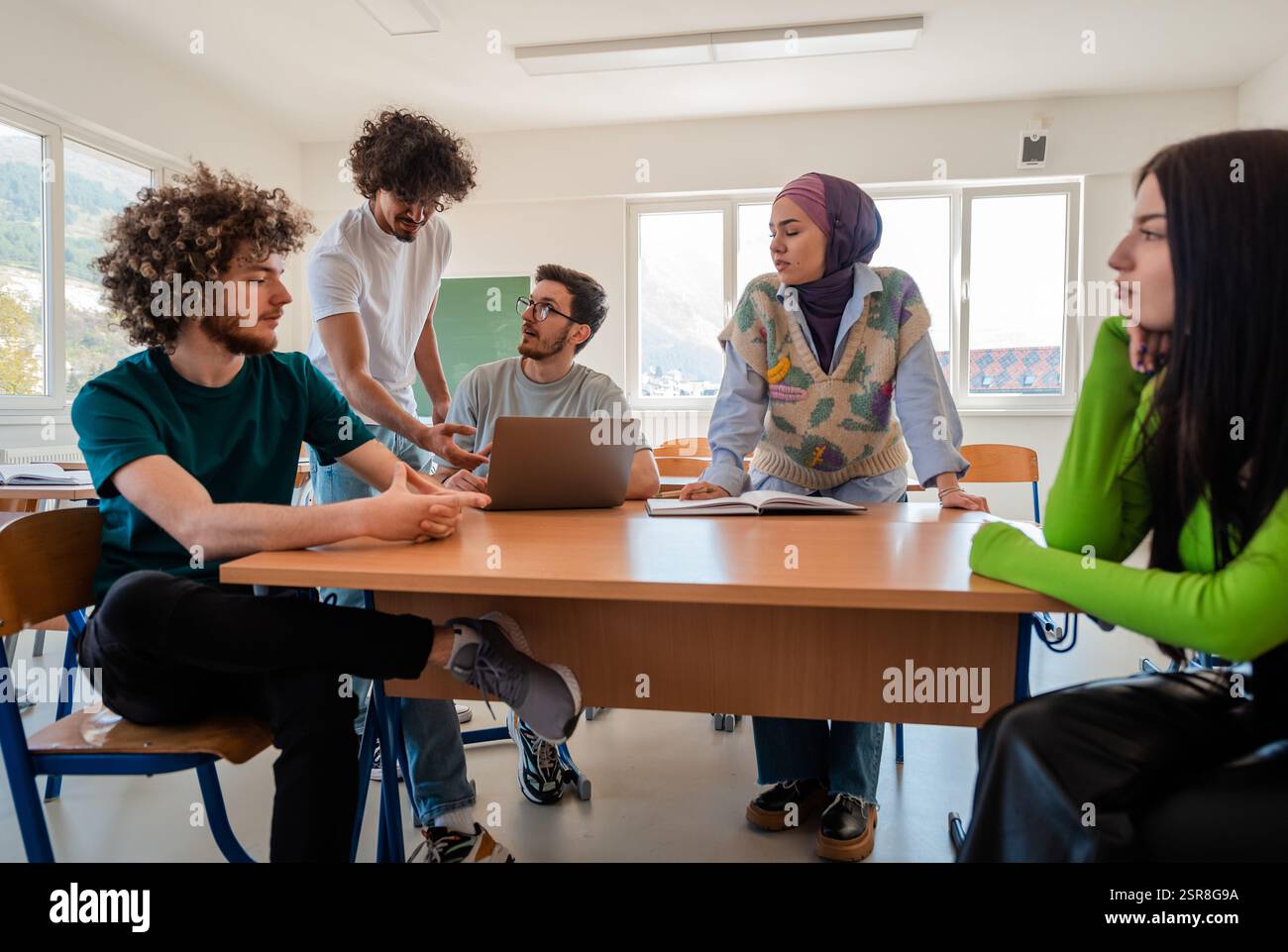 A group of diverse college students studying together or a business ...
