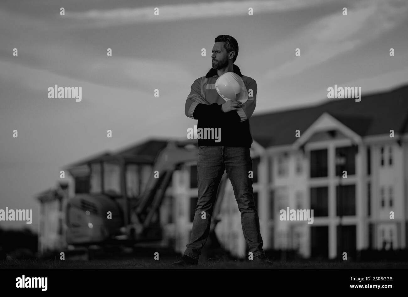 Builder in a construction site. Builder with excavator ready to build ...