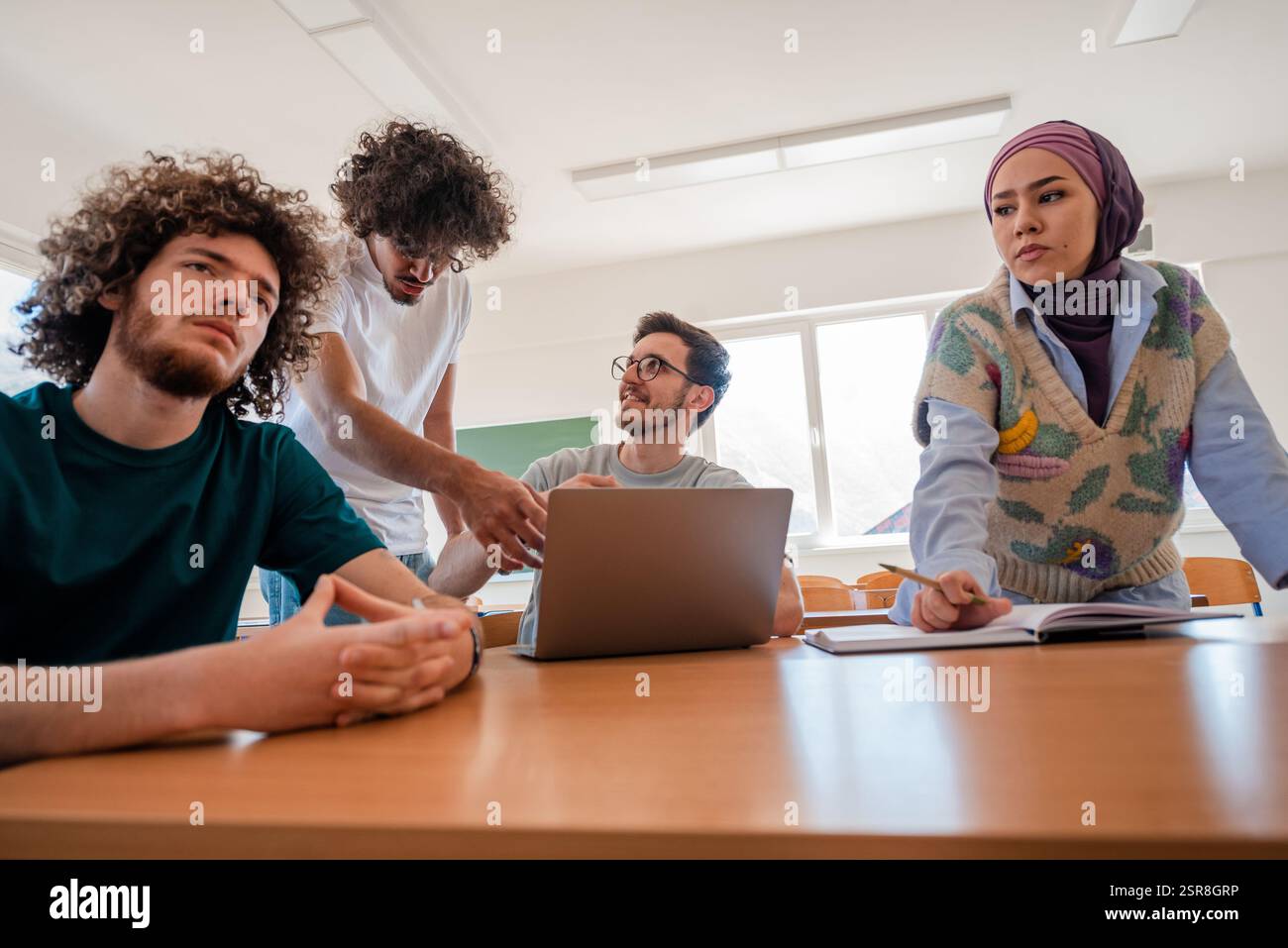 A group of diverse college students studying together or a business ...