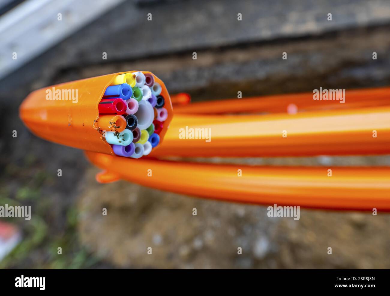 Empty conduits for fibre optic cables, protective conduit in orange ...