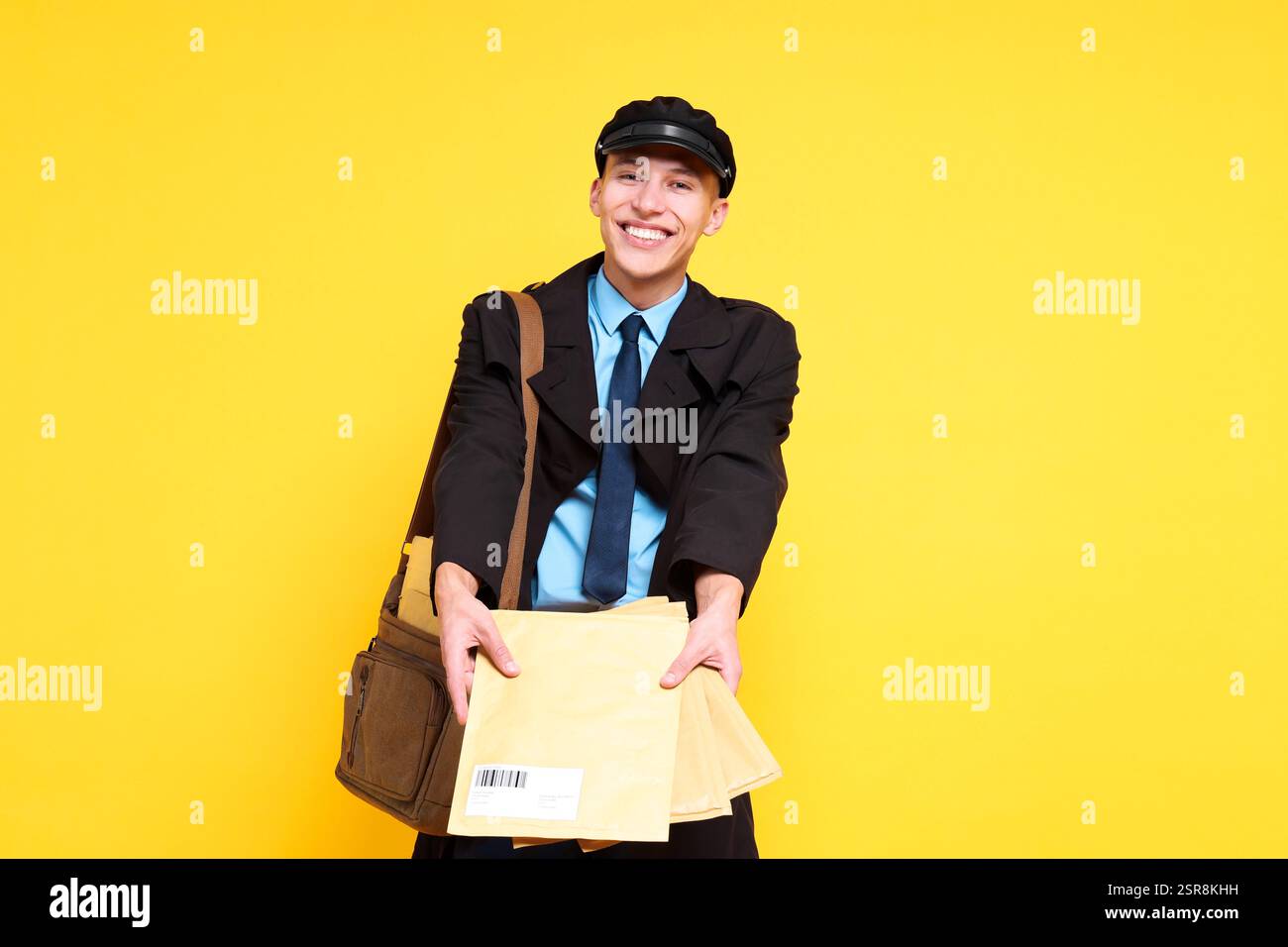 Happy postman with bag and envelopes on yellow background Stock Photo ...
