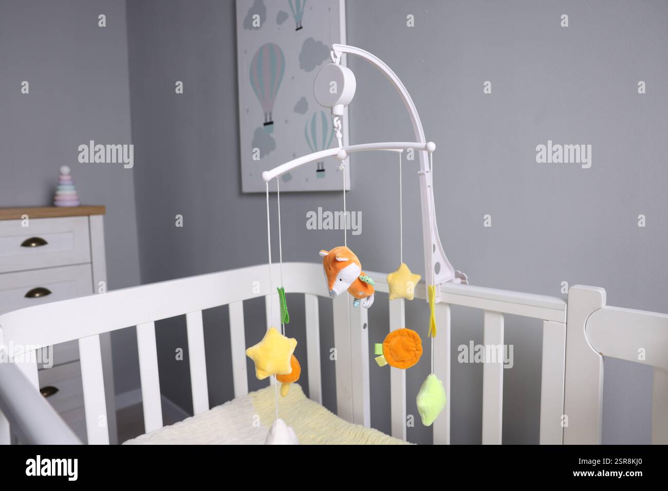 Crib with baby mobile in child's room Stock Photo - Alamy
