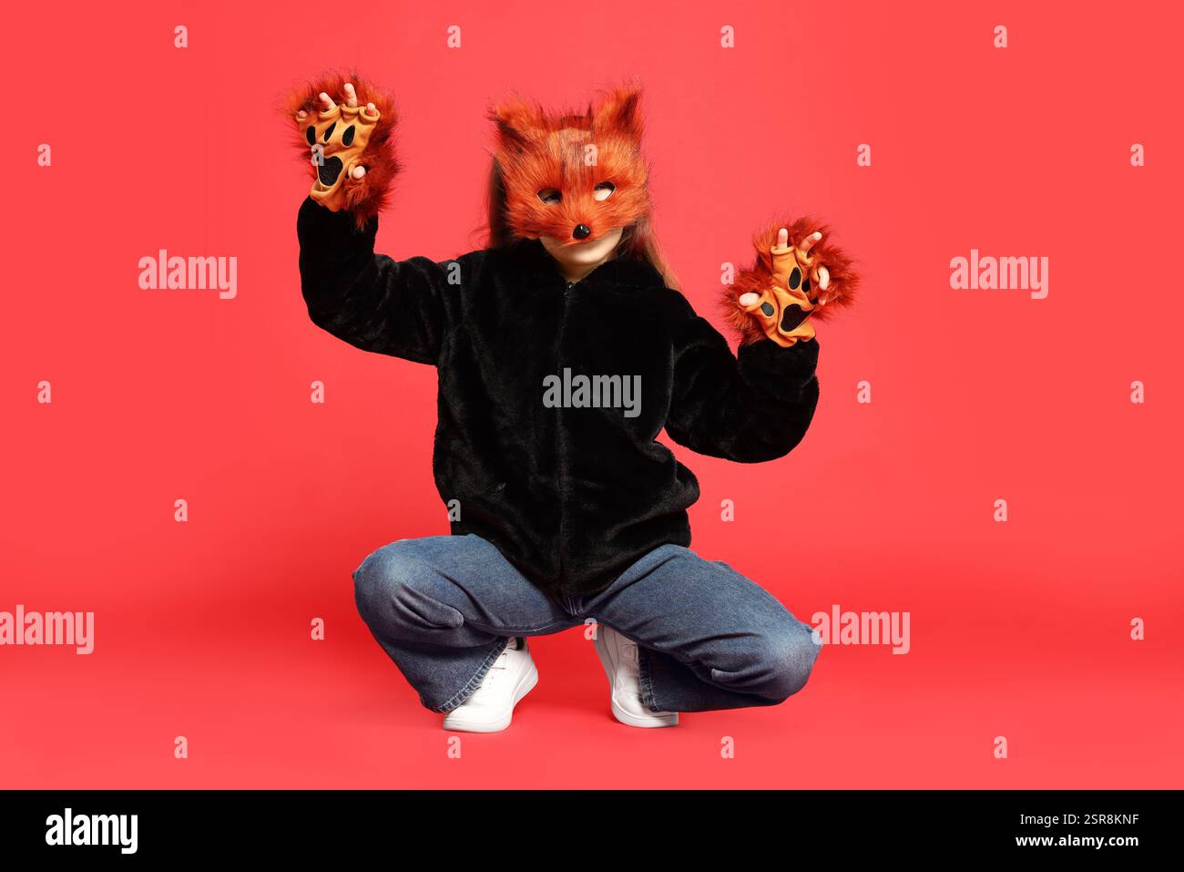 Quadrobics. Girl wearing fox mask and gloves on red background Stock ...