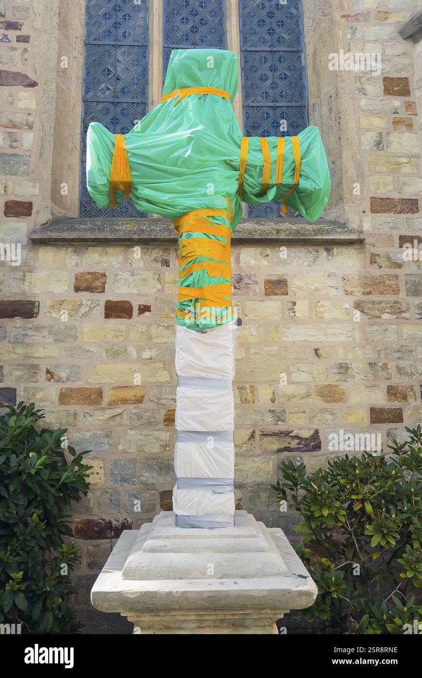 Covered and wrapped cross in front of a church, symbol, church exit ...