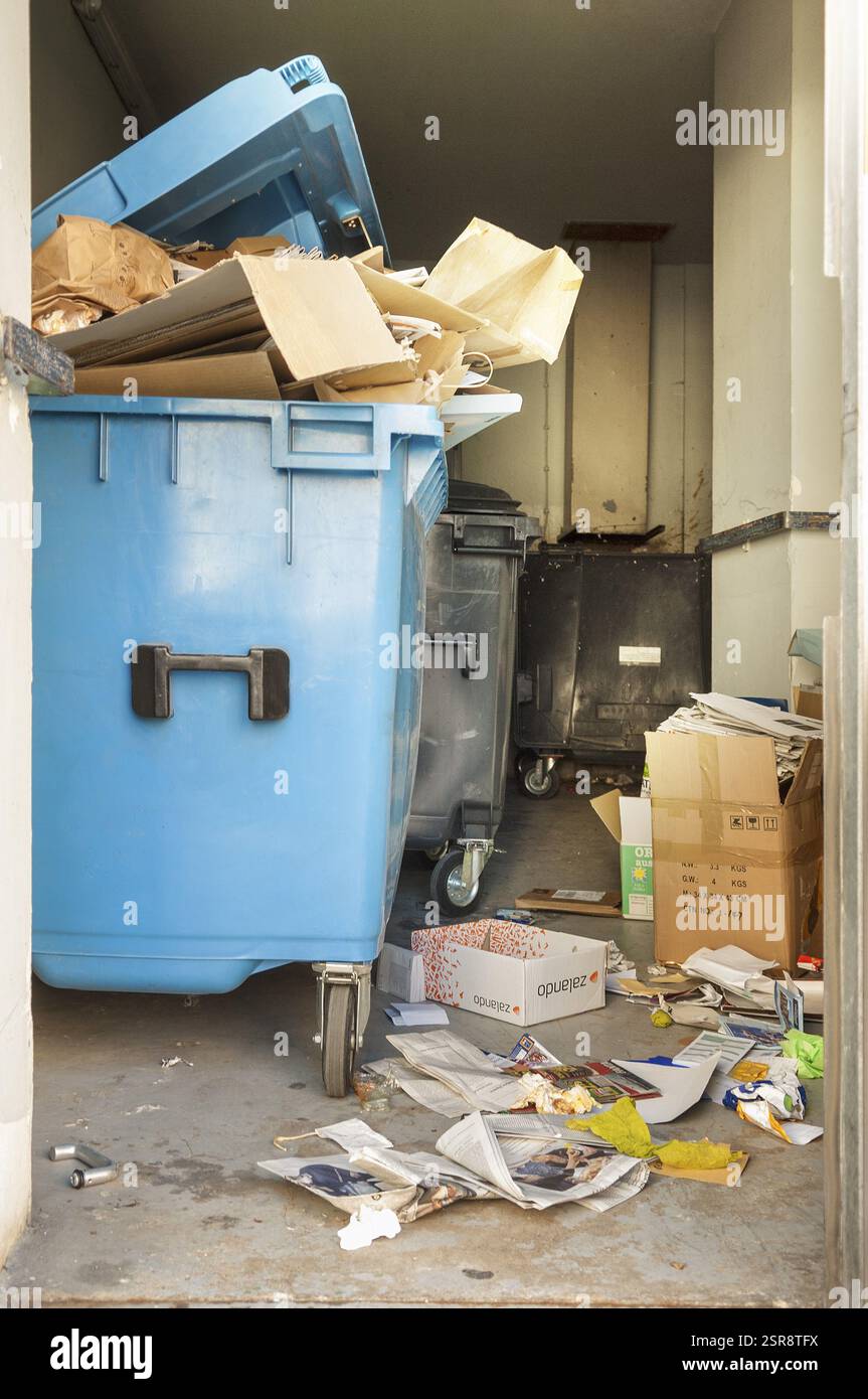 Overfilled blue paper bin, paper waste on the floor Stock Photo - Alamy