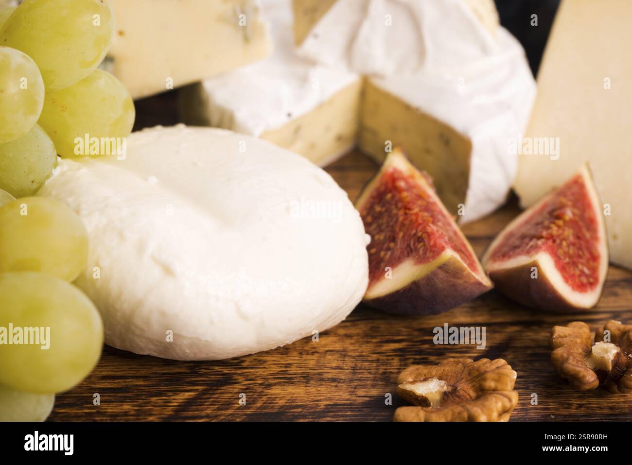 Assortment of cheese with fruits and grapes Stock Photo - Alamy