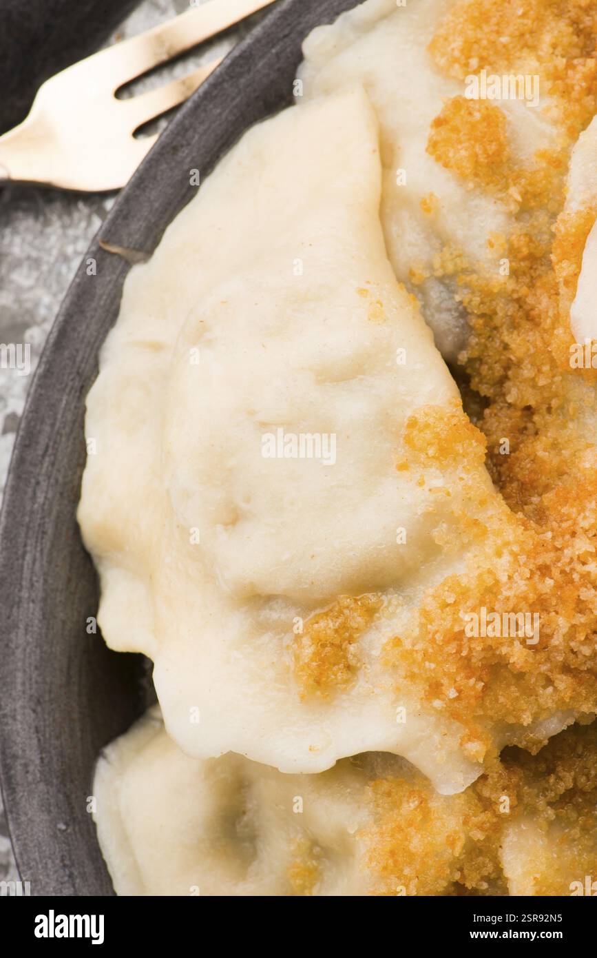 Boiled pierogi (Polish dumplings) stuffed with cabbage and mushrooms ...