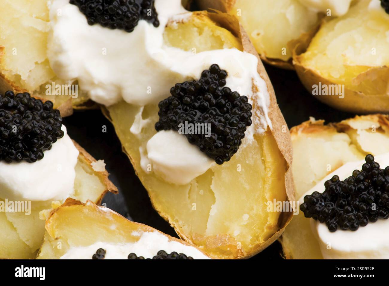 Baked potato with spiced cream cheese and caviar Stock Photo - Alamy