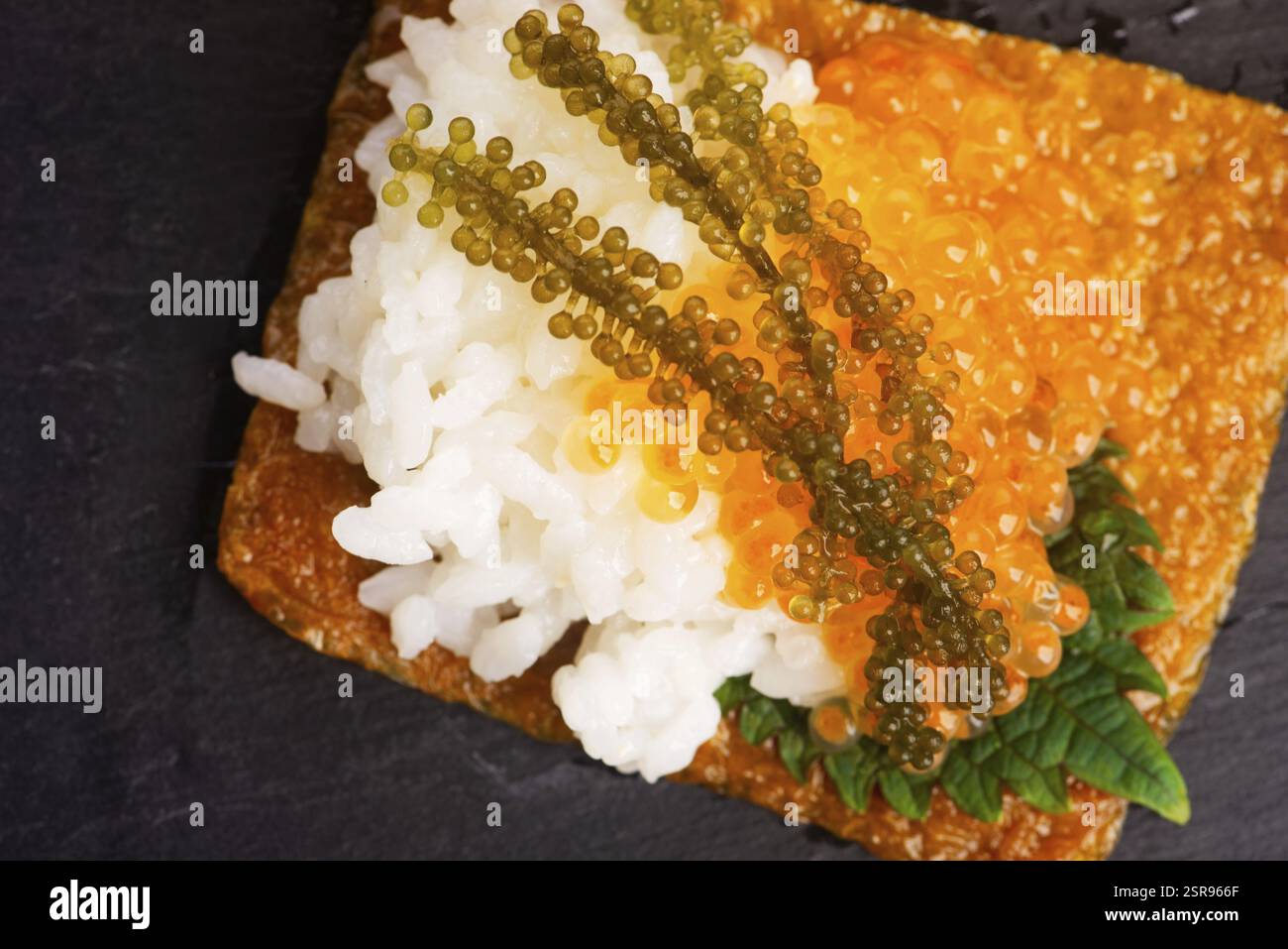 Inari sushi with caviar, rice, shiso and umibudo Stock Photo - Alamy