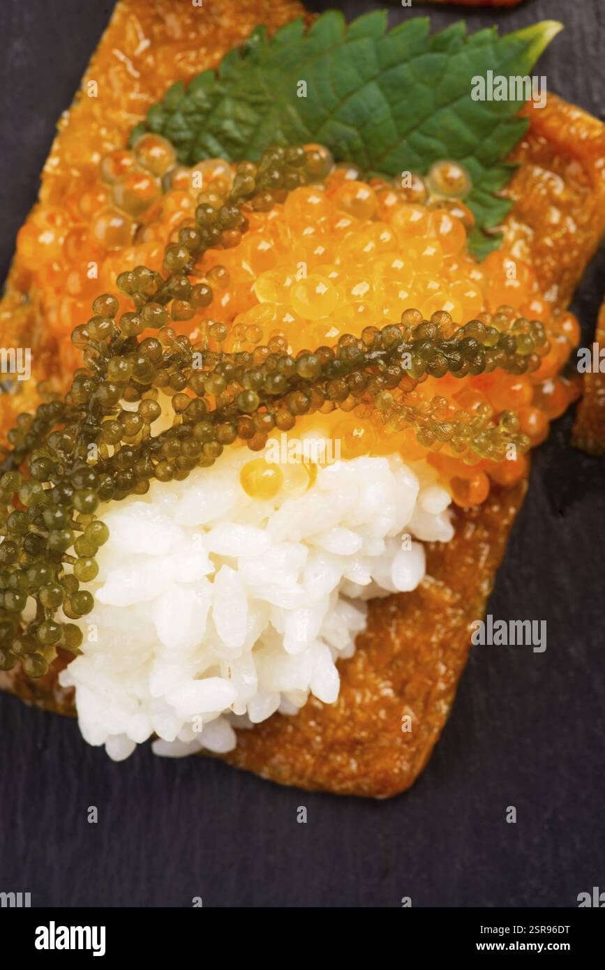 Inari sushi with caviar, rice, shiso and umibudo Stock Photo - Alamy