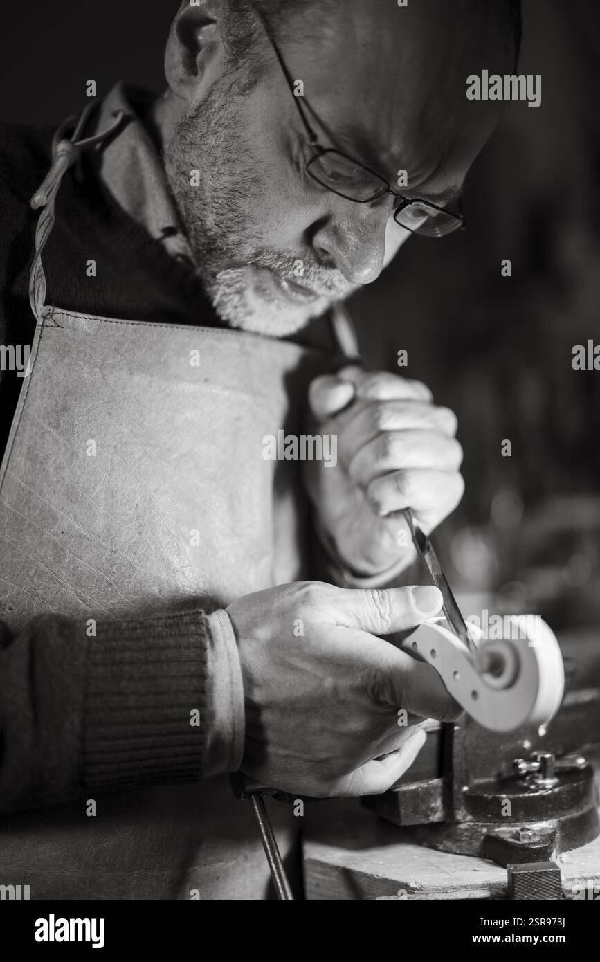 Italian craftsman using a chisel, deeply focused on carving the inside ...