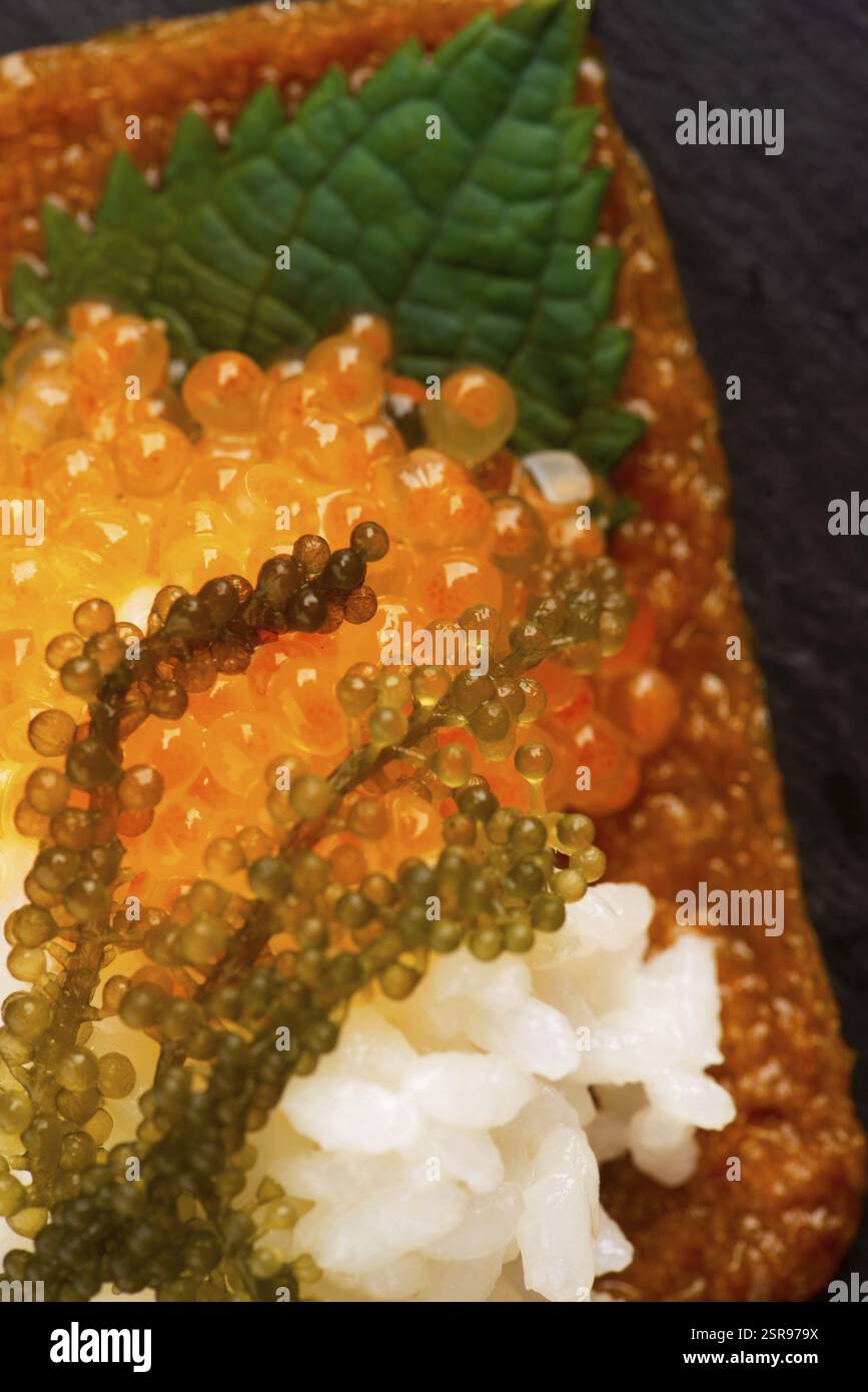 Inari sushi with caviar, rice, shiso and umibudo Stock Photo - Alamy