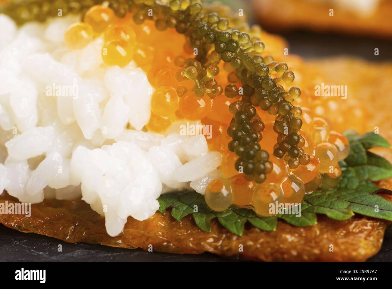 Inari sushi with caviar, rice, shiso and umibudo Stock Photo - Alamy