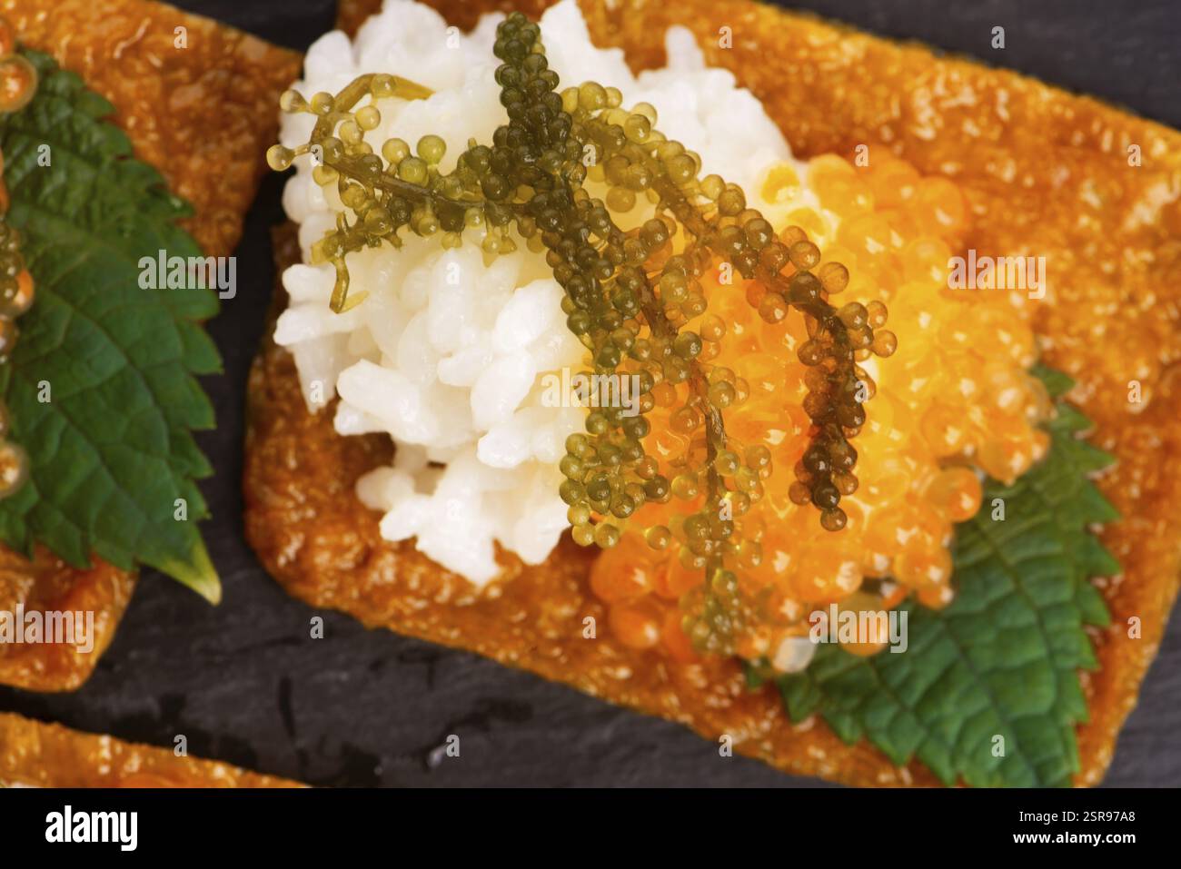 Inari sushi with caviar, rice, shiso and umibudo Stock Photo - Alamy