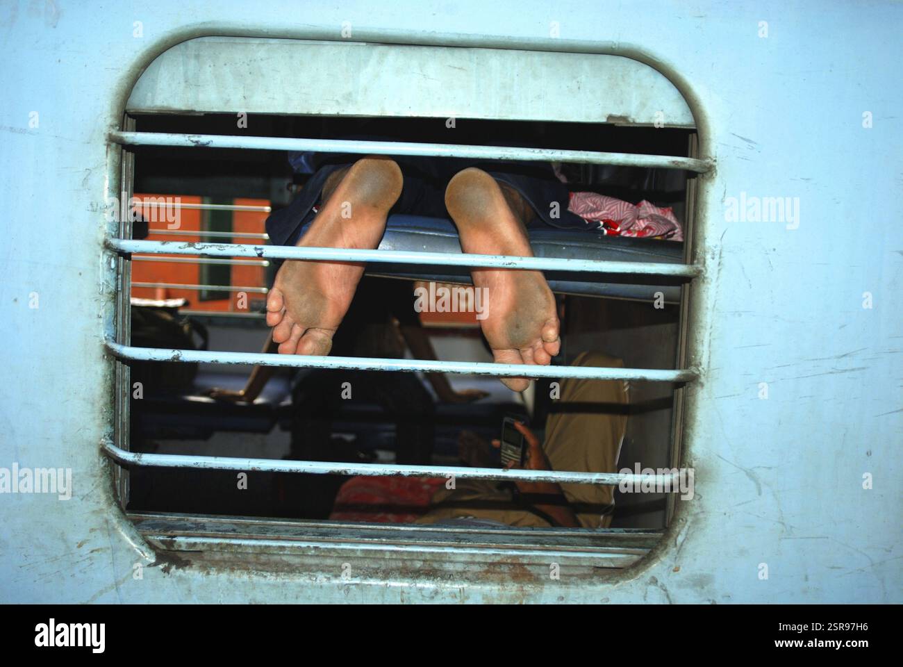 Feet of sleeping traveller on berth in window of train at Jodhpur ...