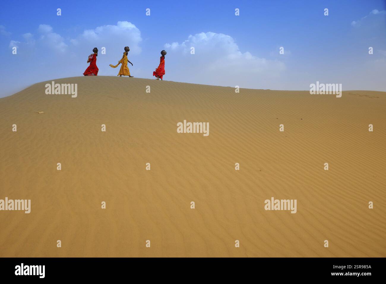 Women carrying water pots going through sand dunes, Jaisalmer, Rajasthan, India, Asia Stock ...