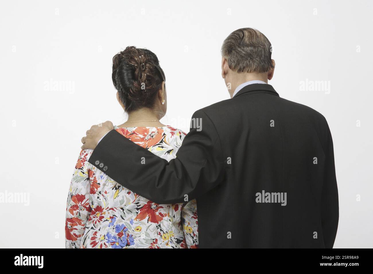 Old couple, old man and woman facing back to camera and hand on left ...