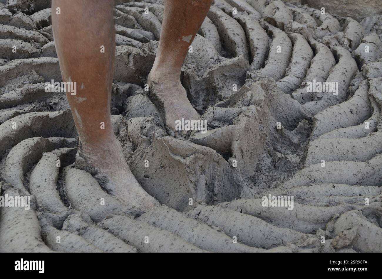 Legs of potter crushing soil at Jodhpur Rajasthan India Stock Photo - Alamy