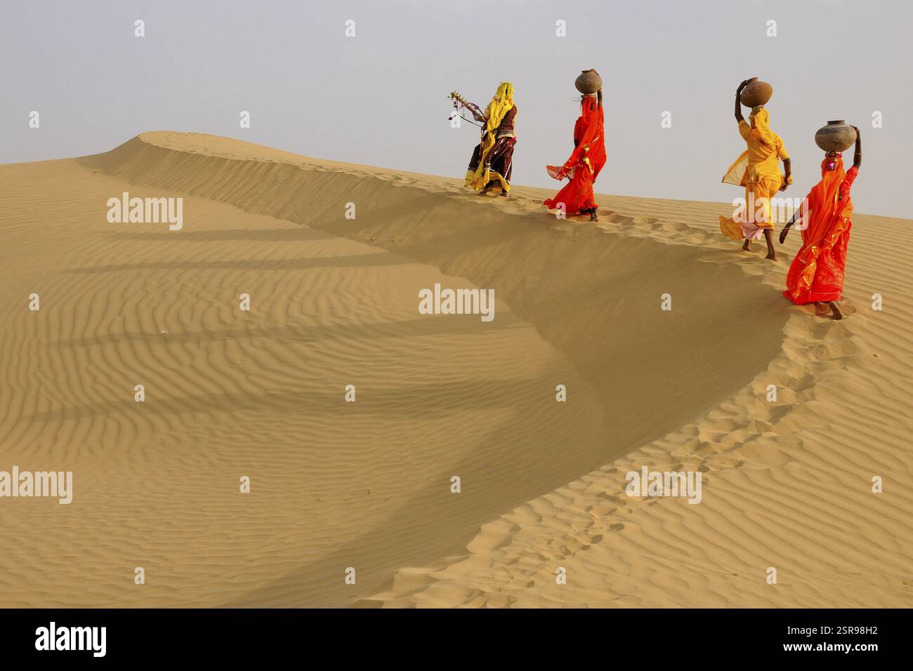 Women carrying water pots going through sand dunes, Jaisalmer, Rajasthan, India, Asia Stock ...