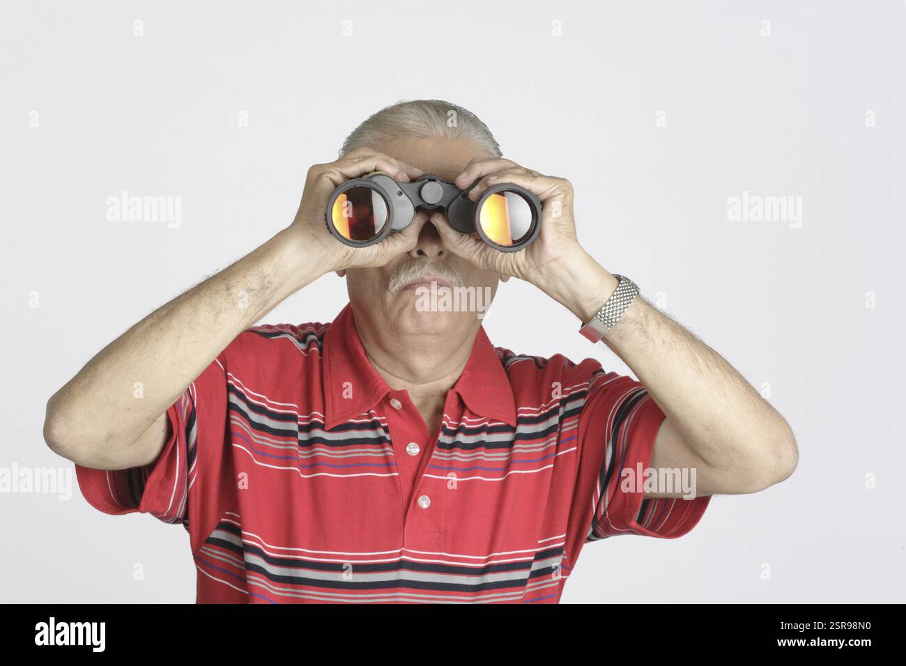 Old man holding binoculars and looking through MR # 703B Stock Photo ...