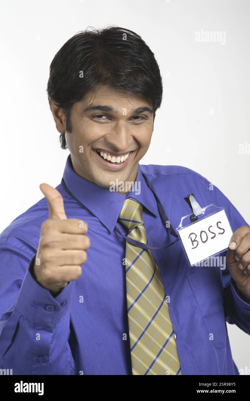 Executive holding Identity card mentioning as Boss showing thumps upMR ...