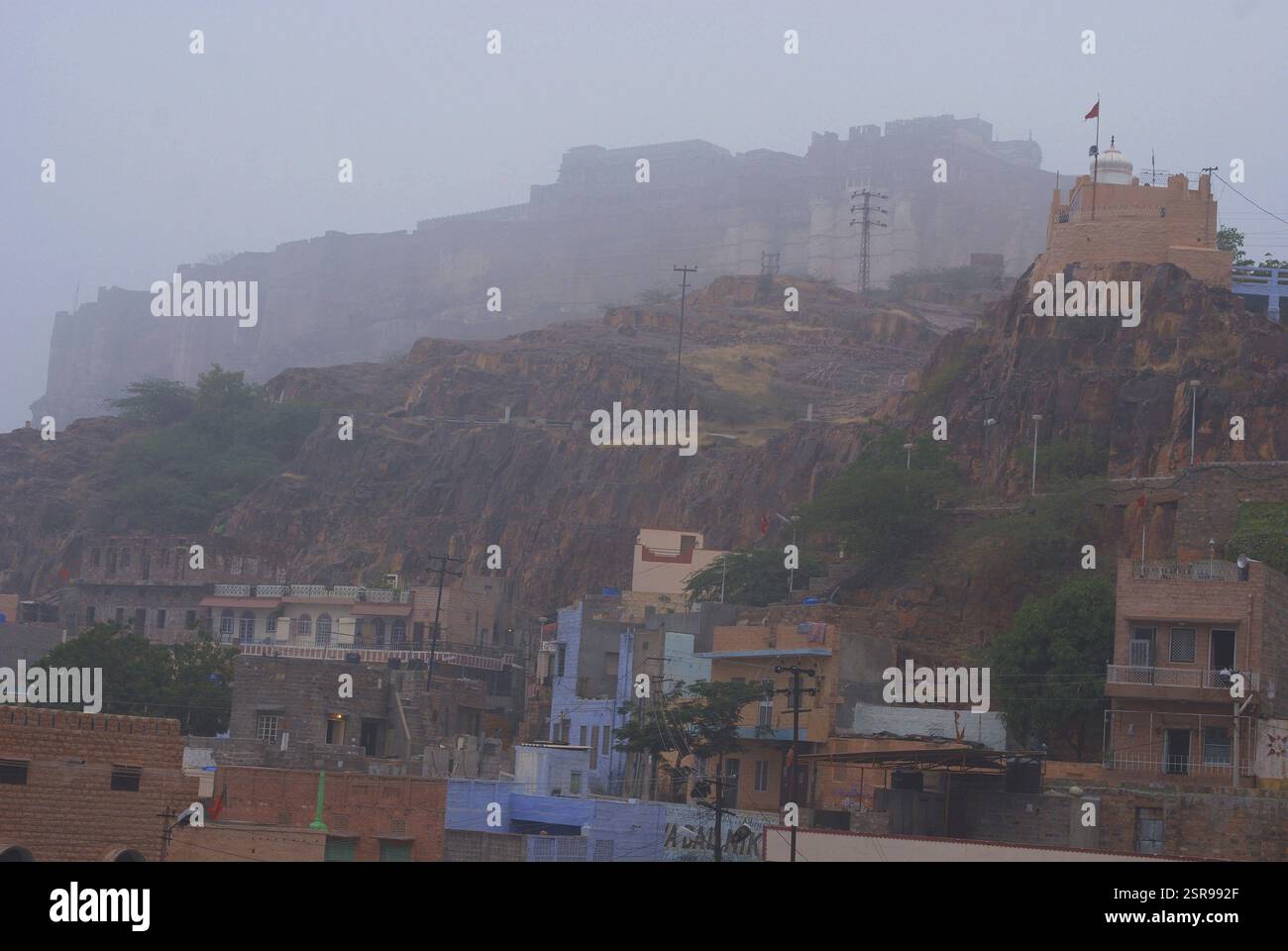 Front facing view of Mehrangarh fort in fog houses in foreground ...
