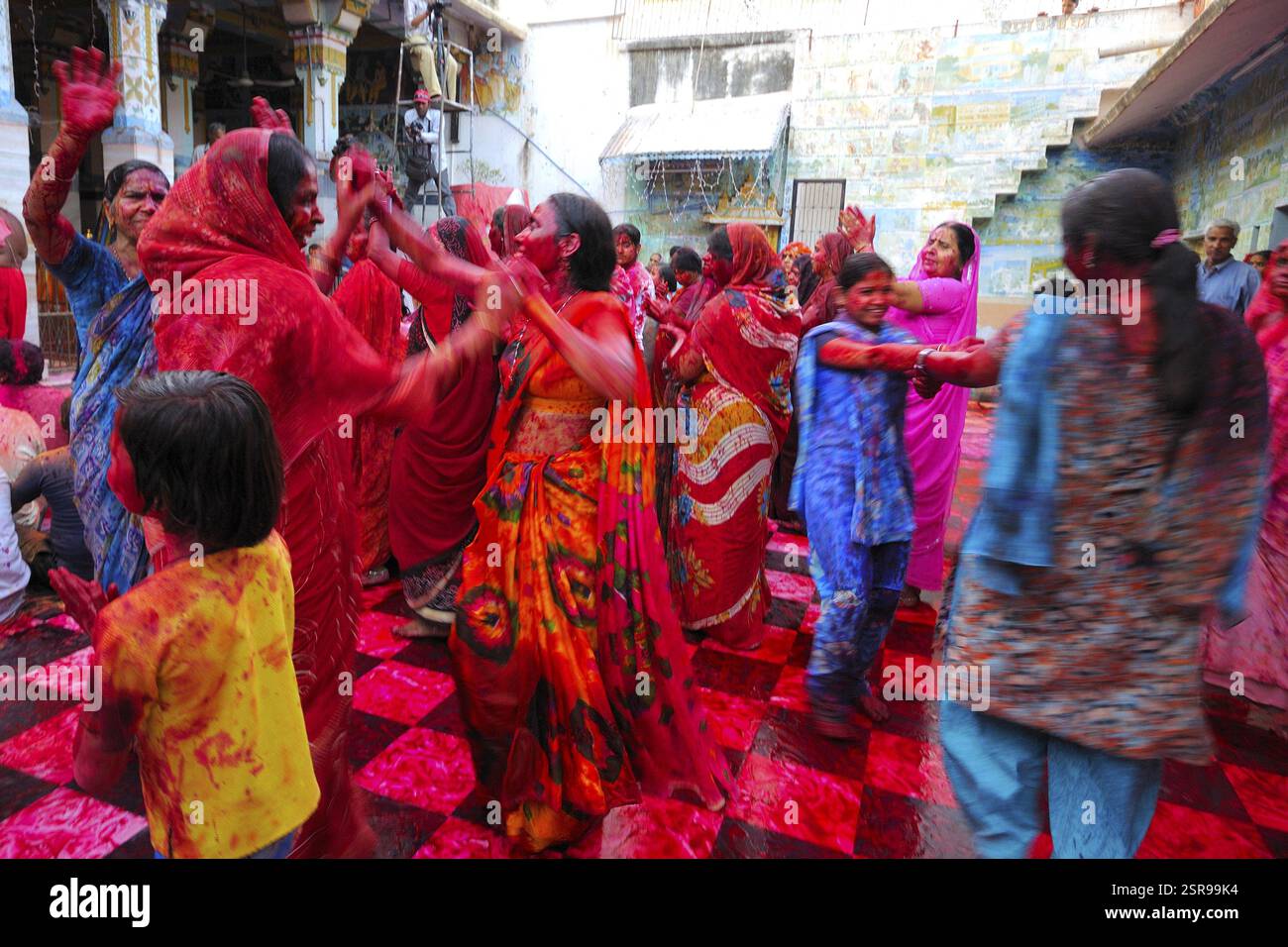 People playing with gulal on holi festival at Ghanshyam Ji temple ...