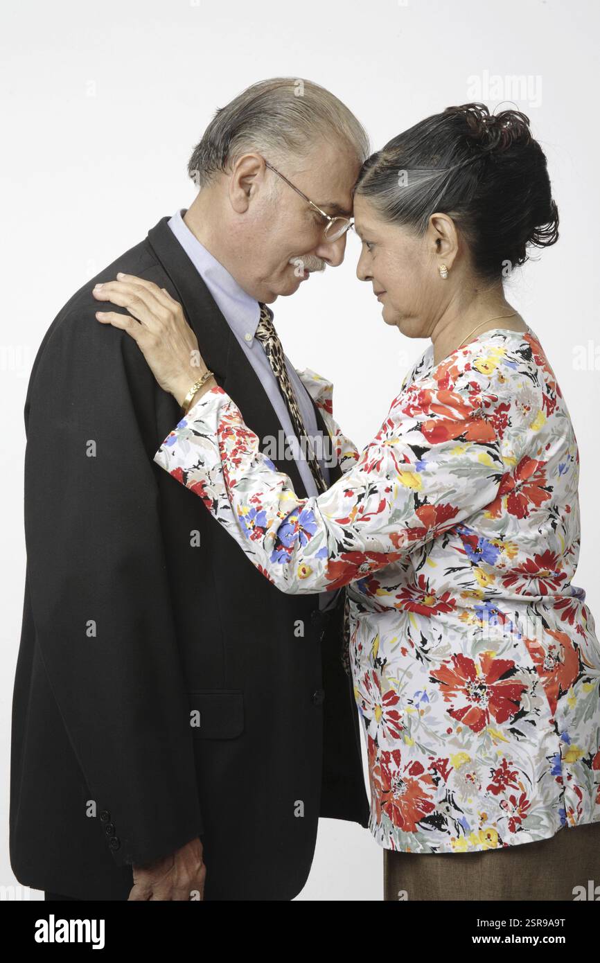 Old couple, old woman touching forehead on old man concerned look MR ...
