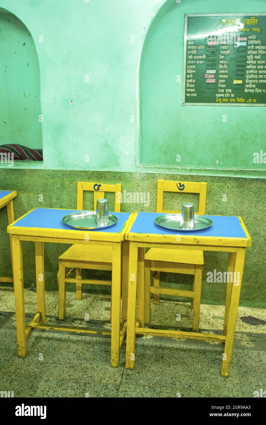 Lunch room with blue and yellow tables and chairs in Kalpana boarding ...