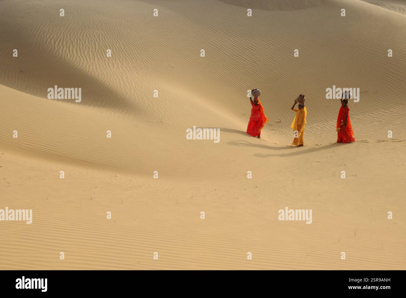 Women carrying water pots and going through sand dunes, Jaisalmer, Rajasthan, India, Asia Stock ...