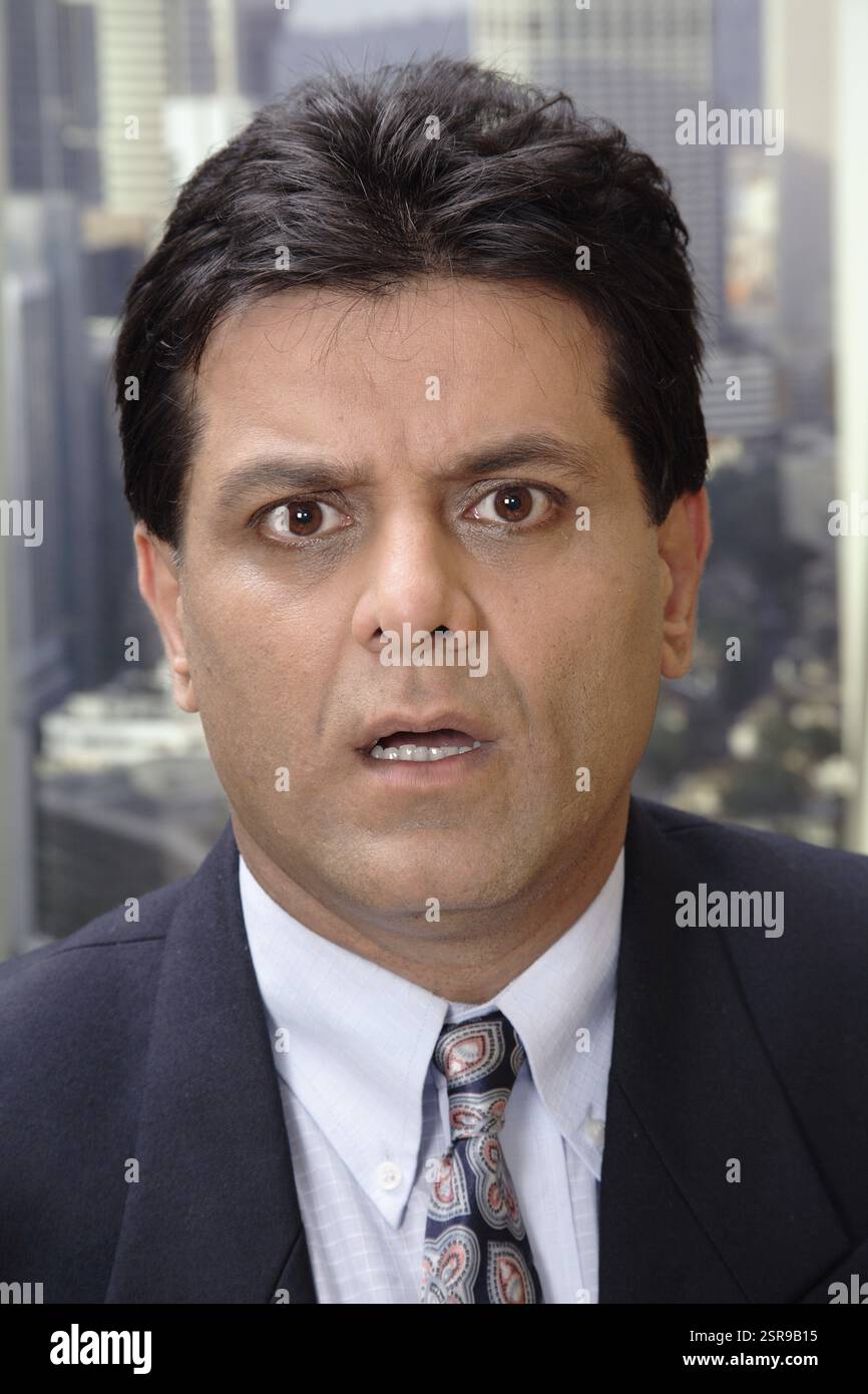 Executive showing expression of surprised and shocked in office at top ...