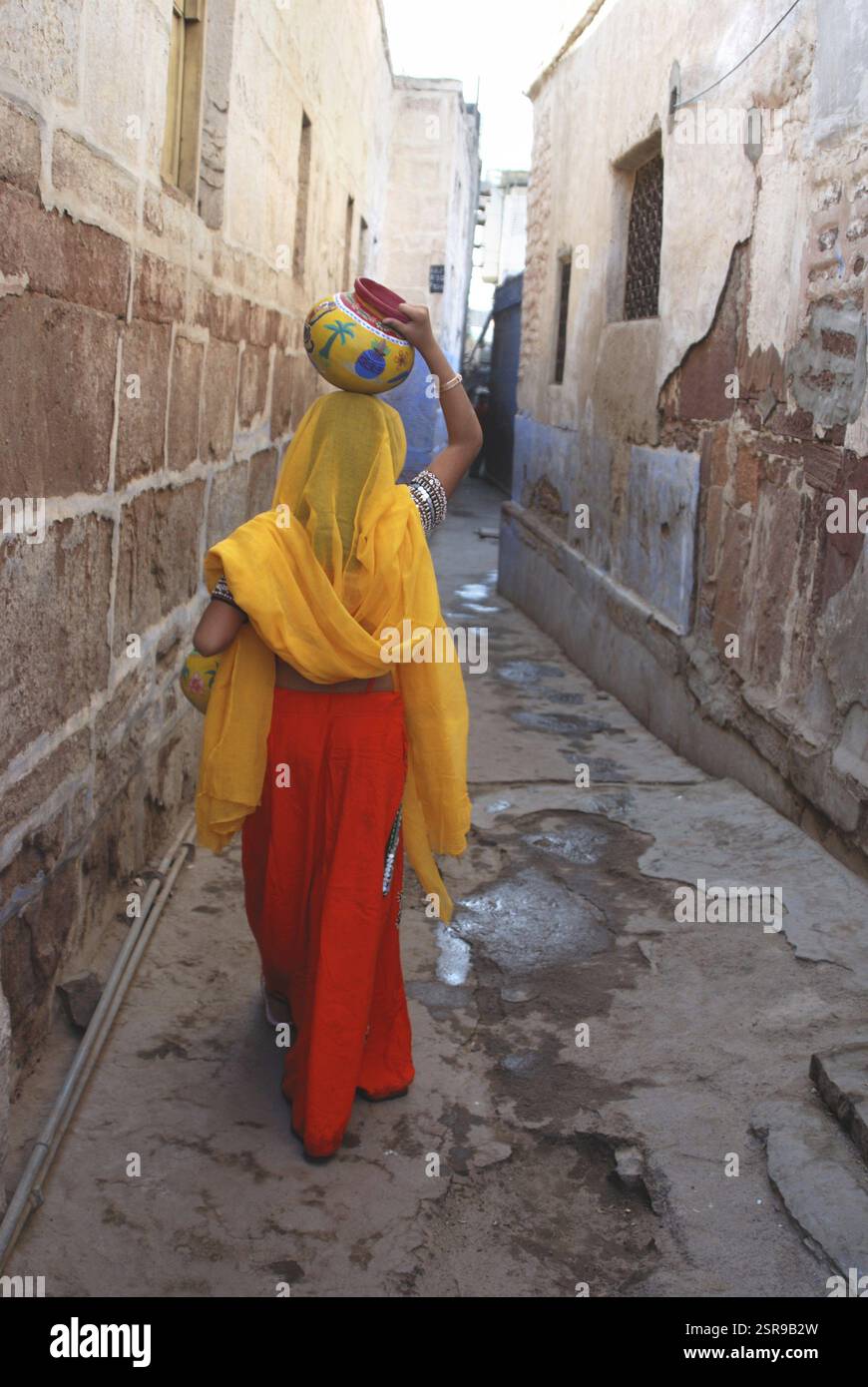 Girl carrying pitcher of water on head in, Jodhpur, Rajasthan, India ...