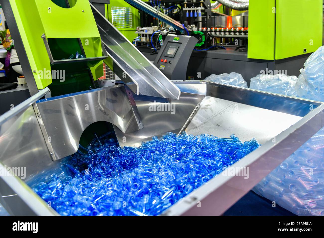 Blue Plastic bottles in production line at manufacturing PET bottle ...