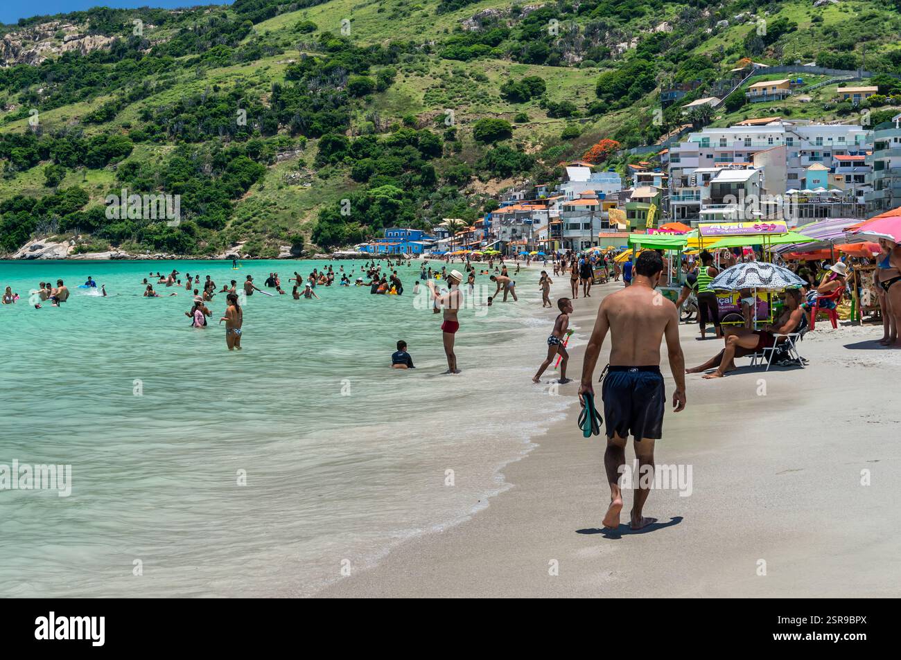 Southeast view of Prainha beach shore crowded with tourists enjoying ...