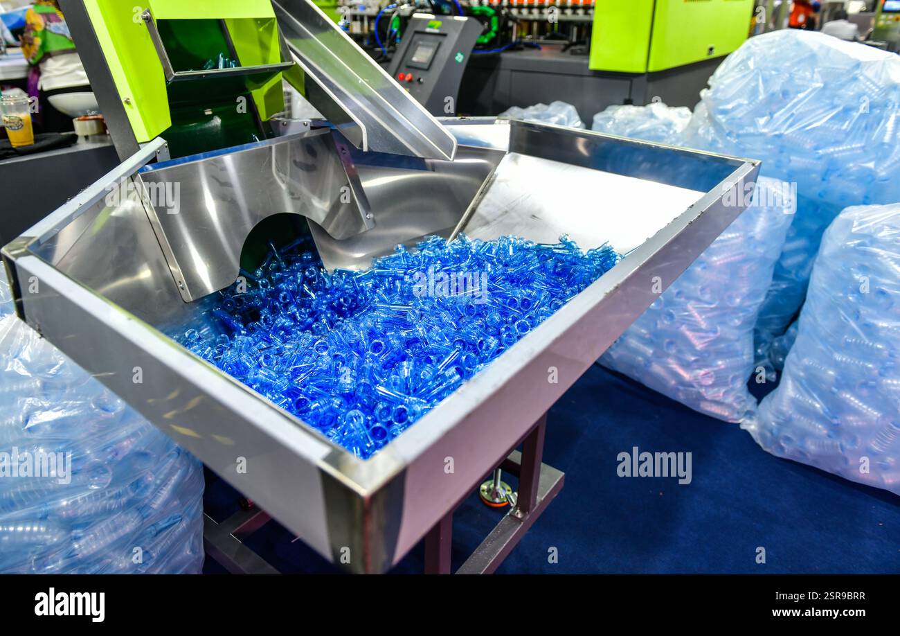 Blue Plastic bottles in production line at manufacturing PET bottle ...