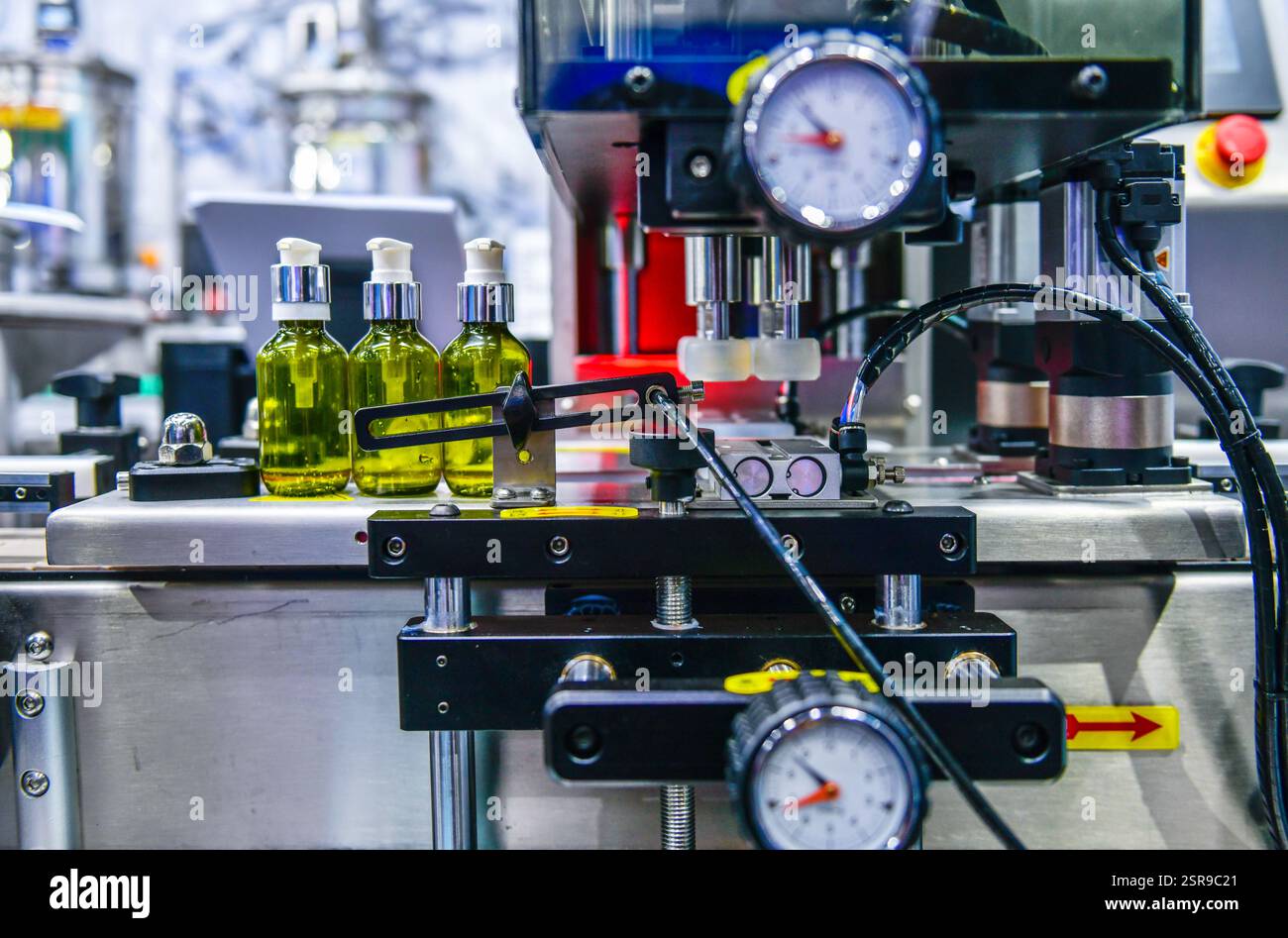 Glass bottles in a conveyor belt on a high quality automatic vertical ...