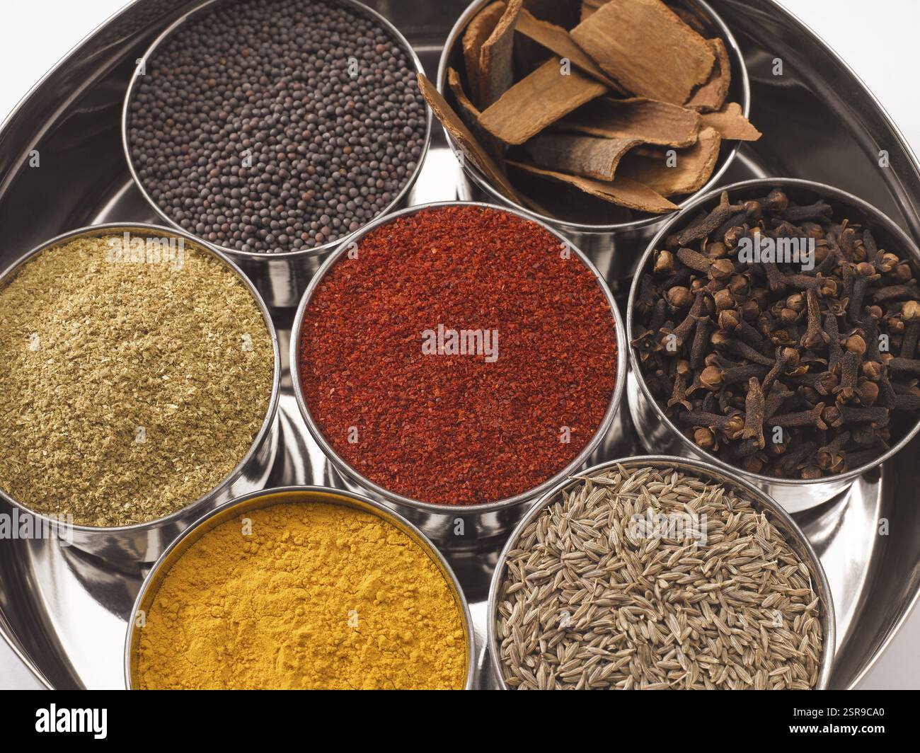 Different types of spices in bowls in stainless steel box on white ...