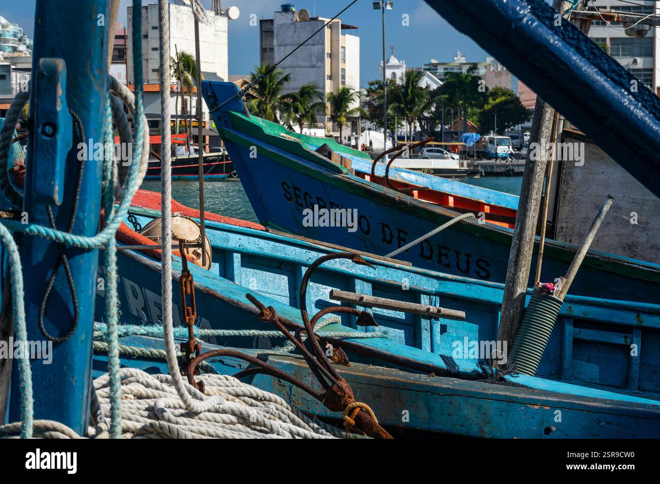 Detailed view of anchored fishing boats with mooring ropes and rusty ...