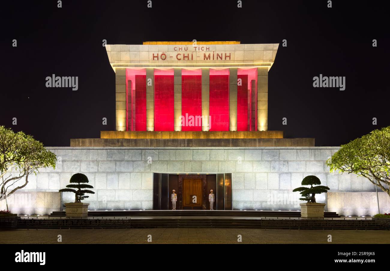 Two white-uniformed soldiers stand guard at night outside the grand and ...