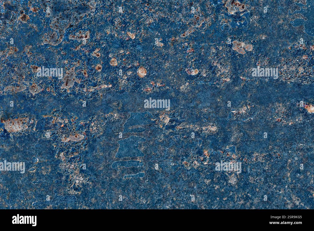 Detailed close-up of a rusty blue metal surface with weathered patterns, corrosion spots, and ...