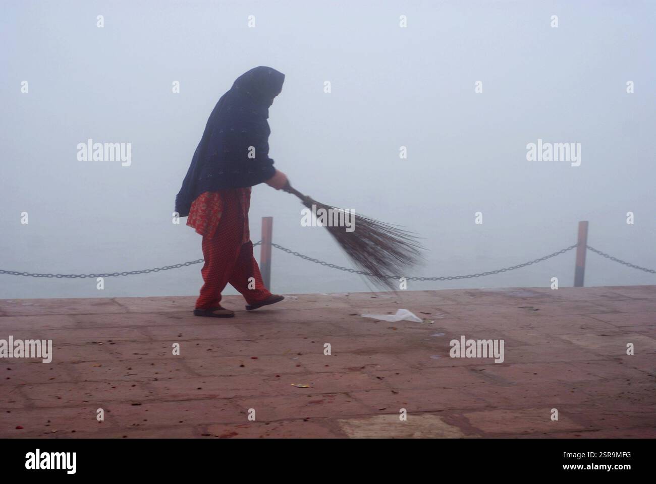 Sweeper cleaning ghat of river ganga ganges, Haridwar, Uttaranchal ...