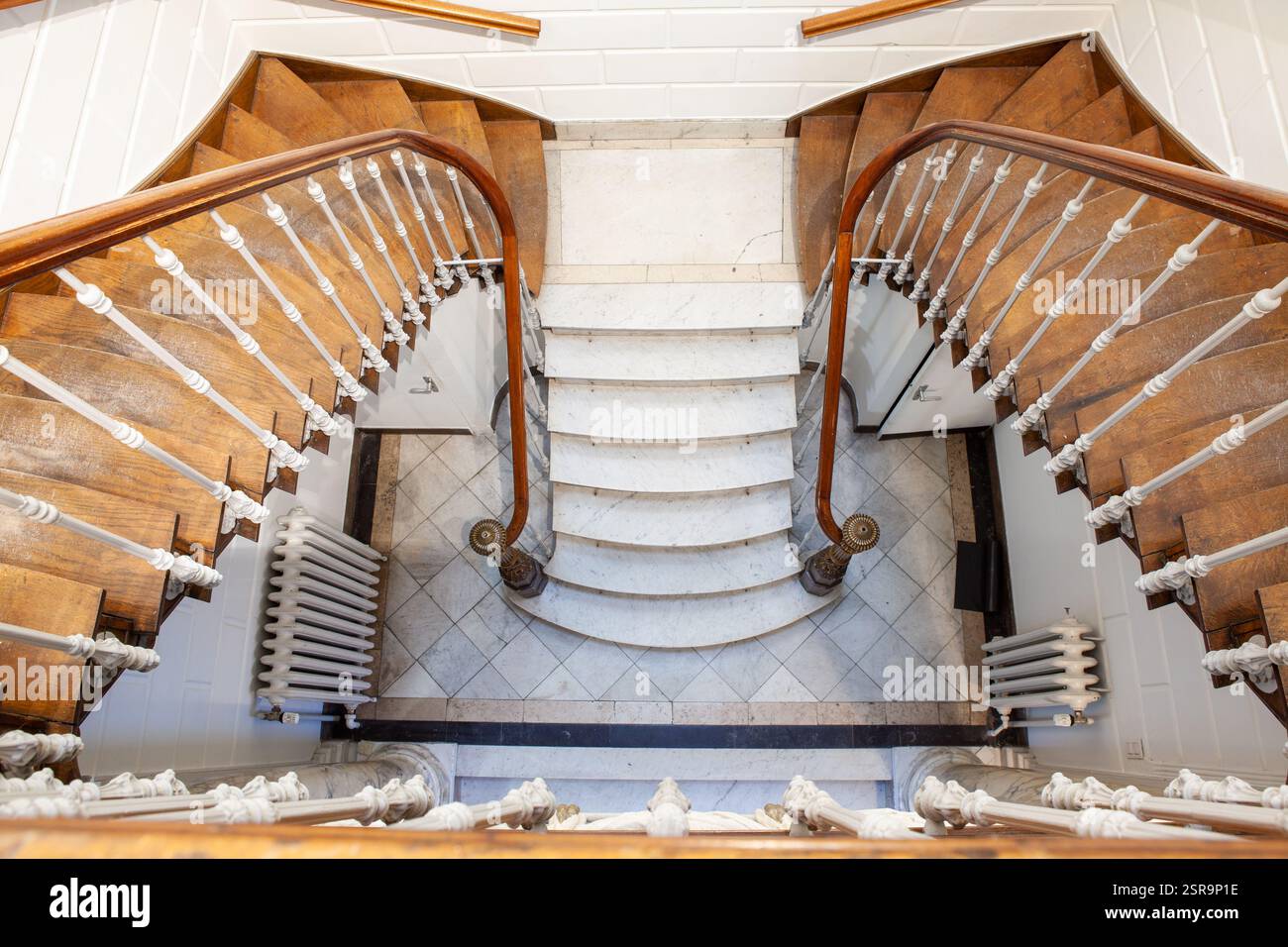 This marble and an wouden staircase that splits in two in an old ...