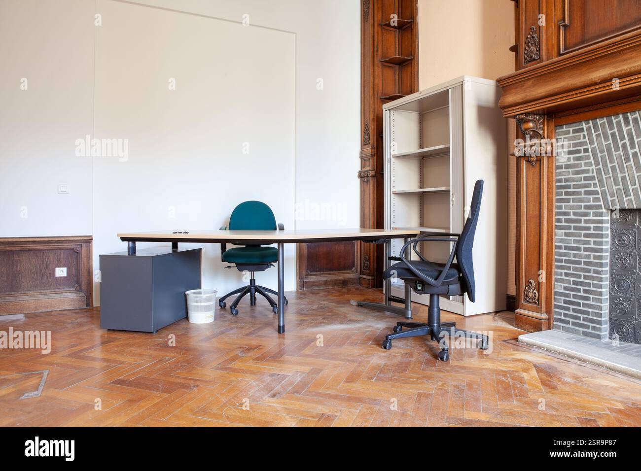 next to an old fireplace there is a desk in an old mansion Stock Photo ...