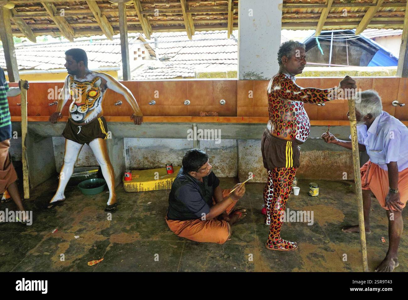 Artists painting bodies for Pulikali Tiger Dance, Onam festival ...