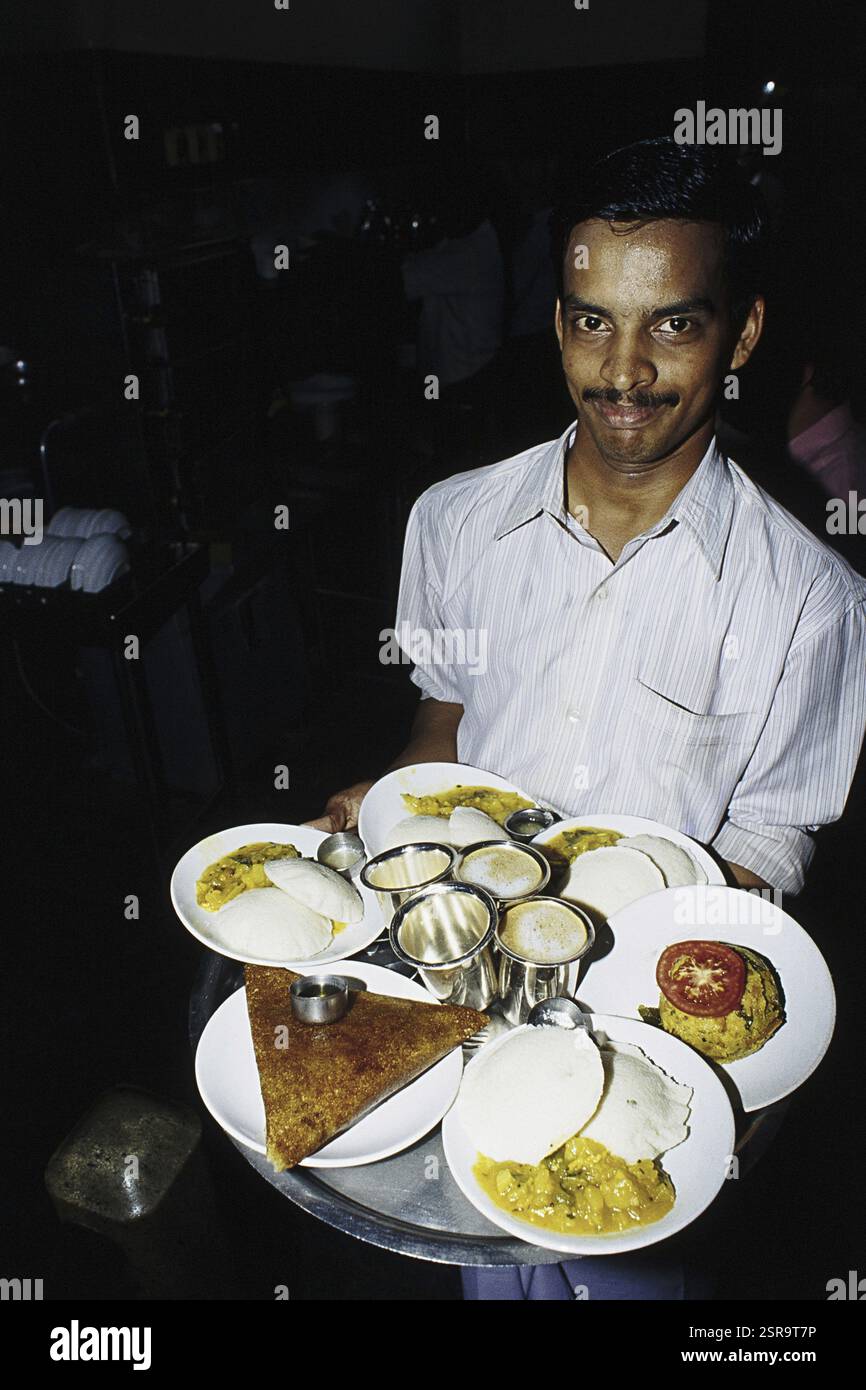 MTR restaurant waiter showing various dishes, Karnataka, India, Asia ...