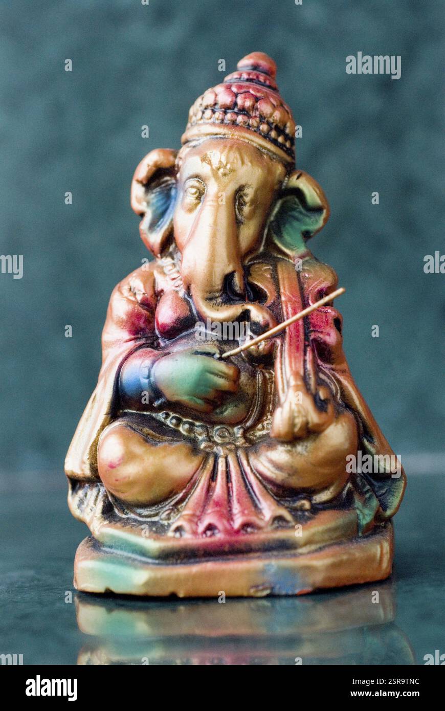 Lord Ganesha ganpati plaster Idol sitting colourful playing violin ...