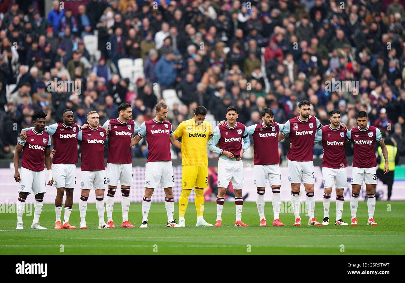 The West Ham United players stand before a minute's applause in tribute ...