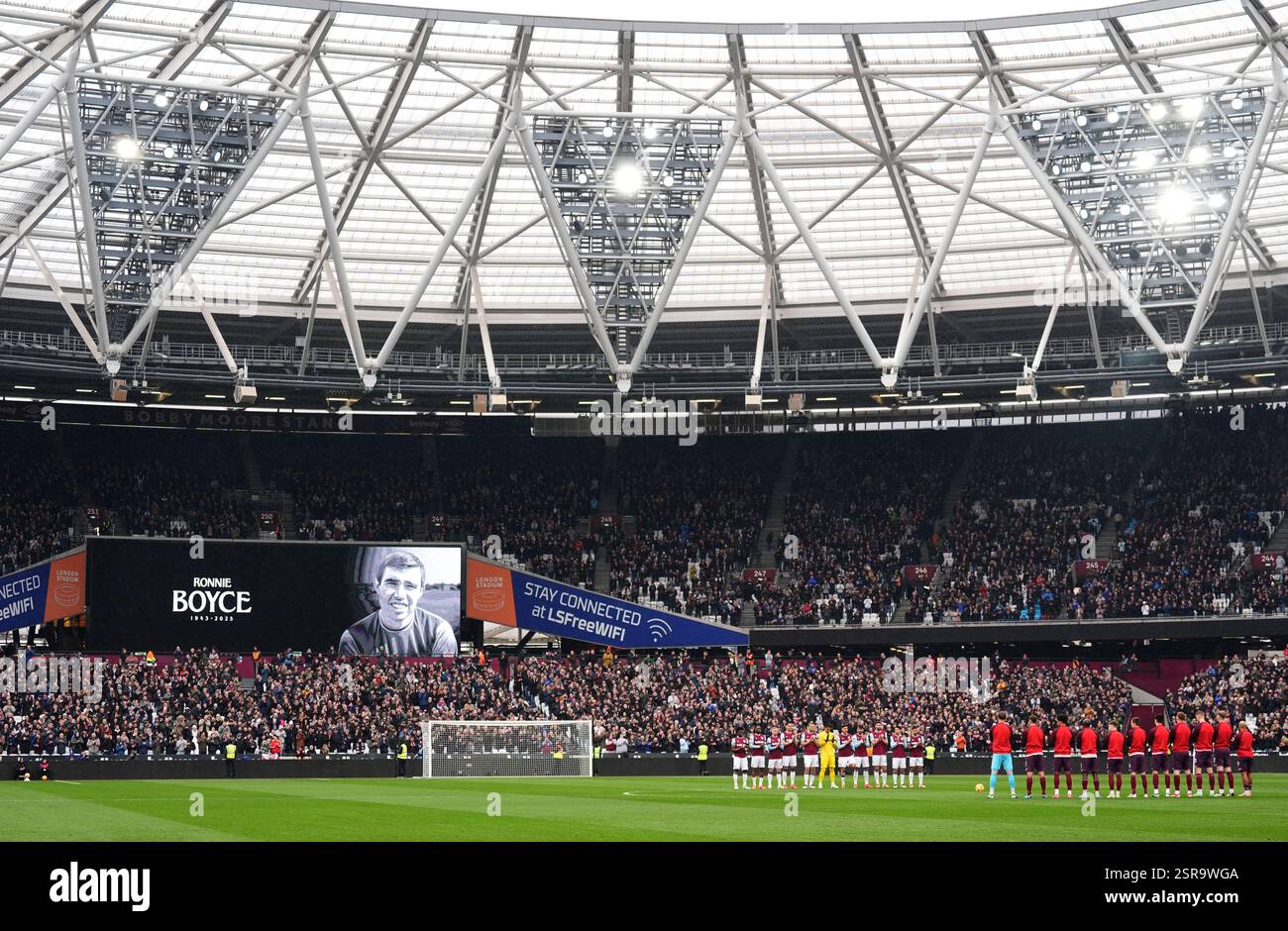 West Ham United and Brentford players stand before a minute's applause ...