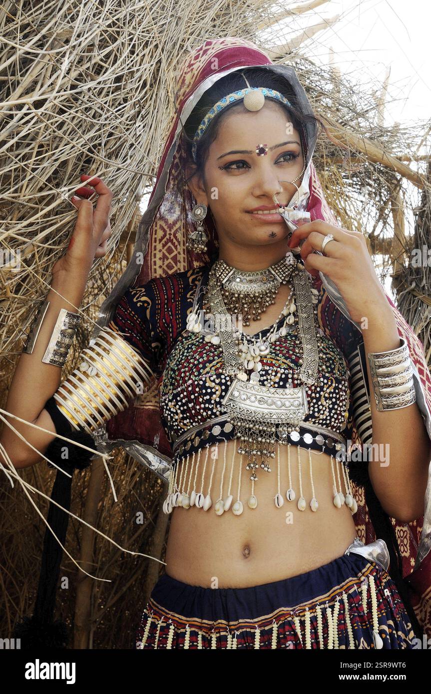 Rajasthani lady standing in front of hut, Jaisalmer, Rajasthan, India ...