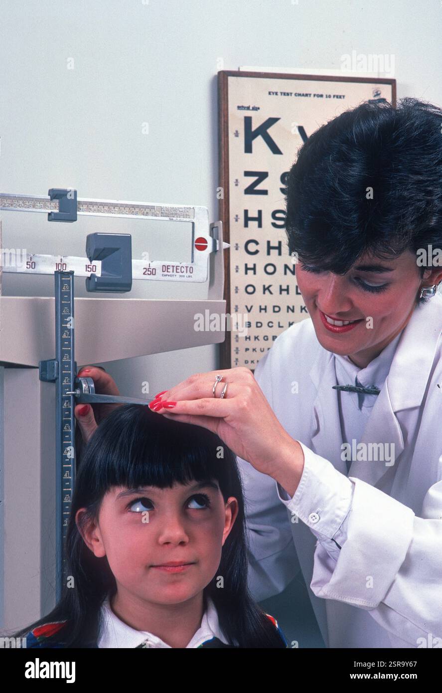 Child gets her height measured at a medical checkup appointment in New ...